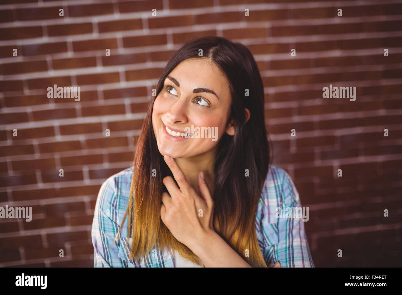 Pretty hipster smiling and thinking Stock Photo - Alamy