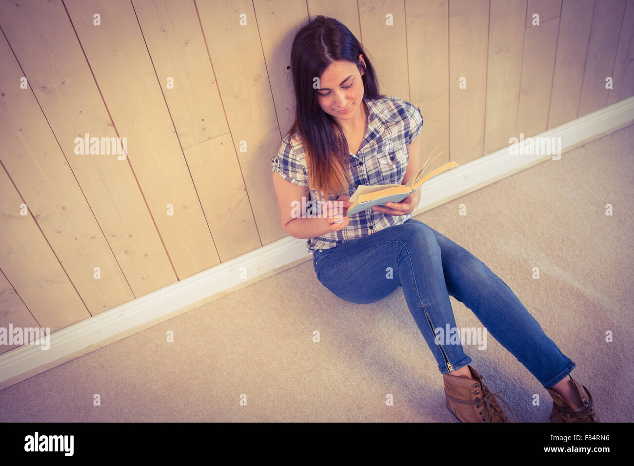 Pretty hipster reading blue book Stock Photo - Alamy