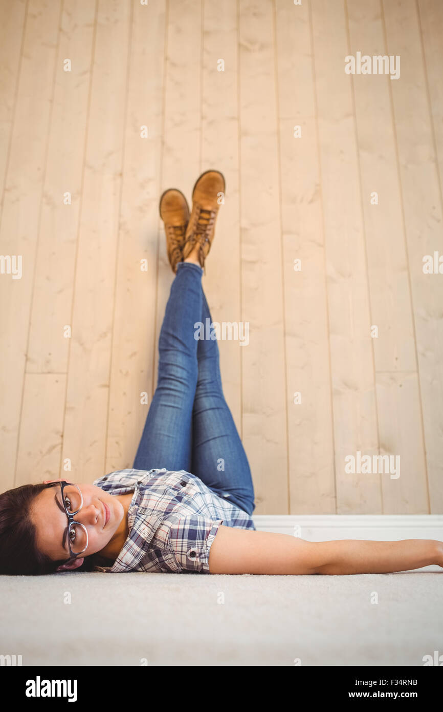 Pretty hipster with legs on wall Stock Photo - Alamy