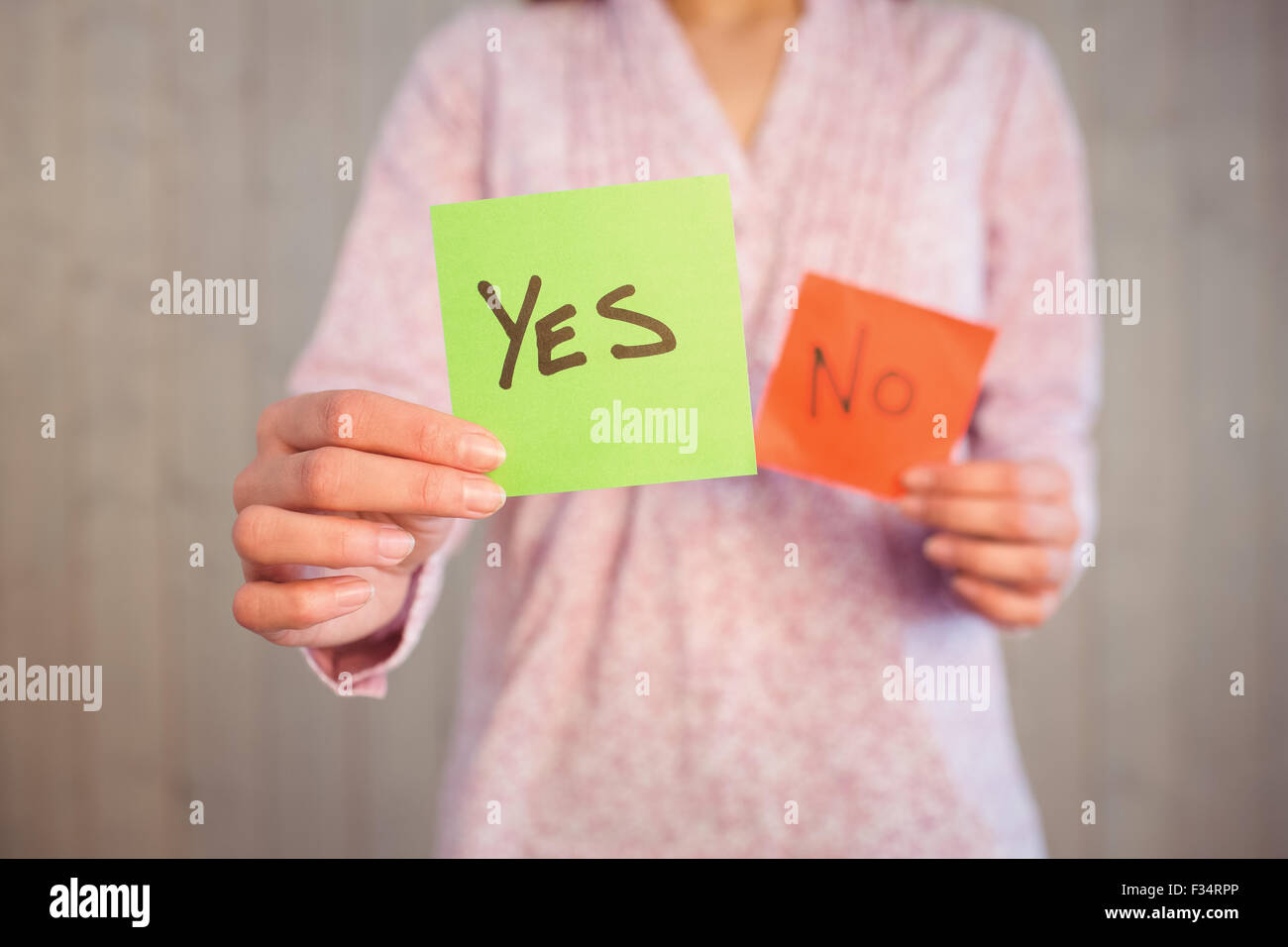 Woman holding yes and no cards Stock Photo - Alamy