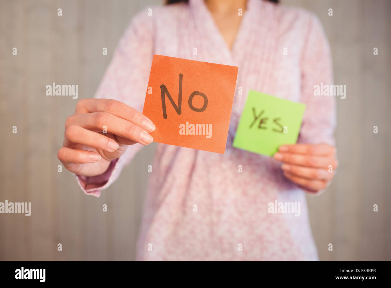 Woman holding yes and no cards Stock Photo - Alamy