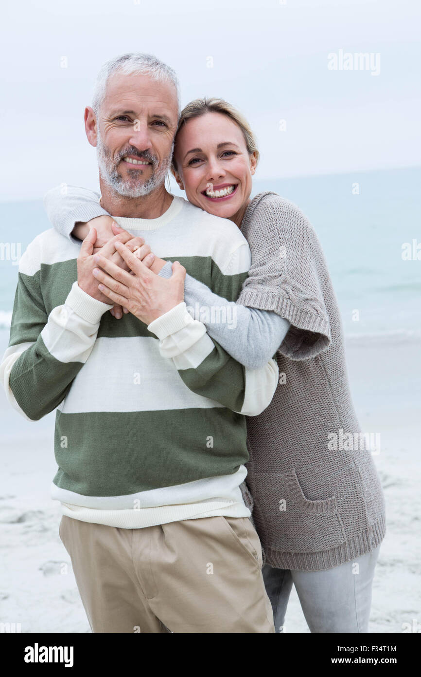Smiling couple holding hands and hugging Stock Photo - Alamy