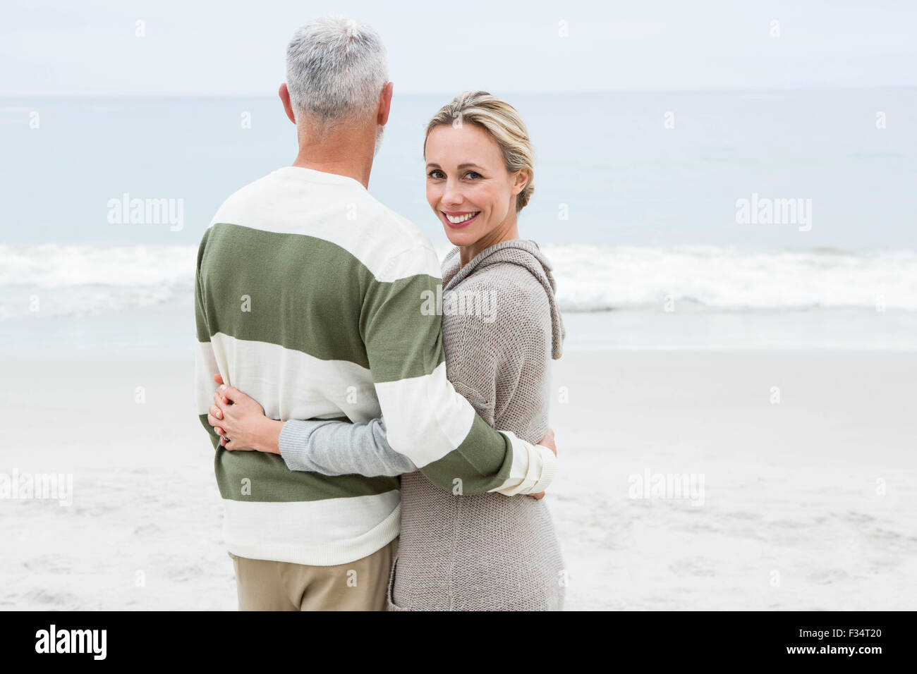 Woman hugging her partner Stock Photo - Alamy