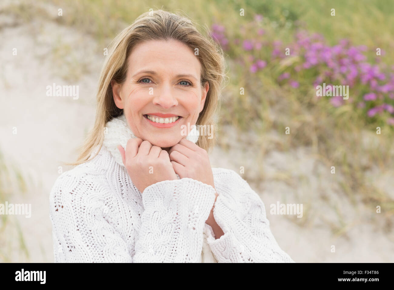 Woman smiling near the sandy hill Stock Photo - Alamy