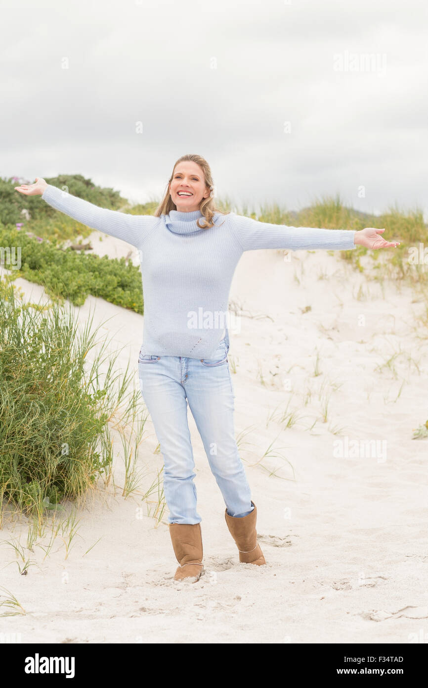 Smiling woman standing with open arms Stock Photo - Alamy