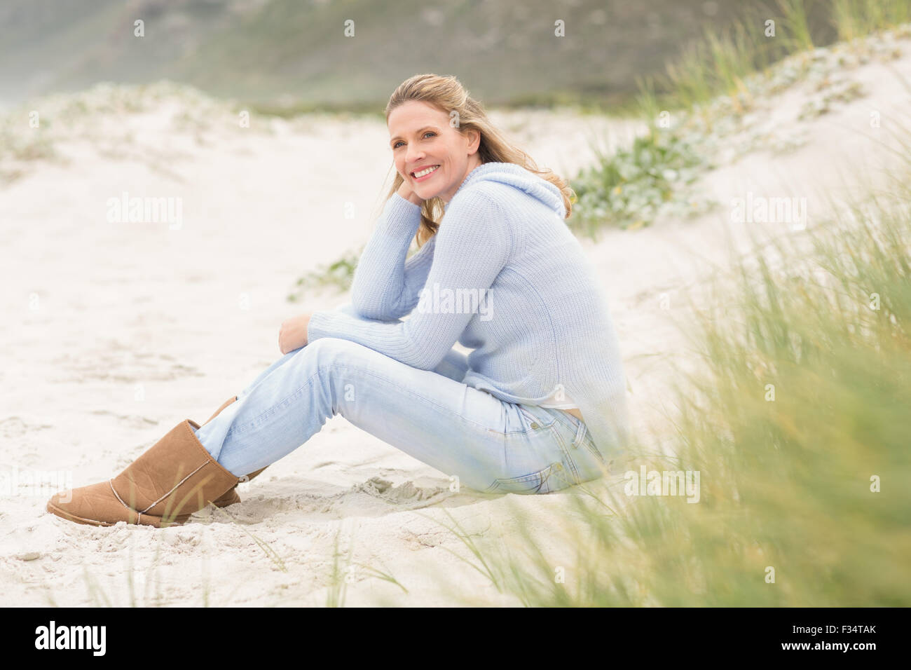 Woman sitting sand hi-res stock photography and images - Alamy