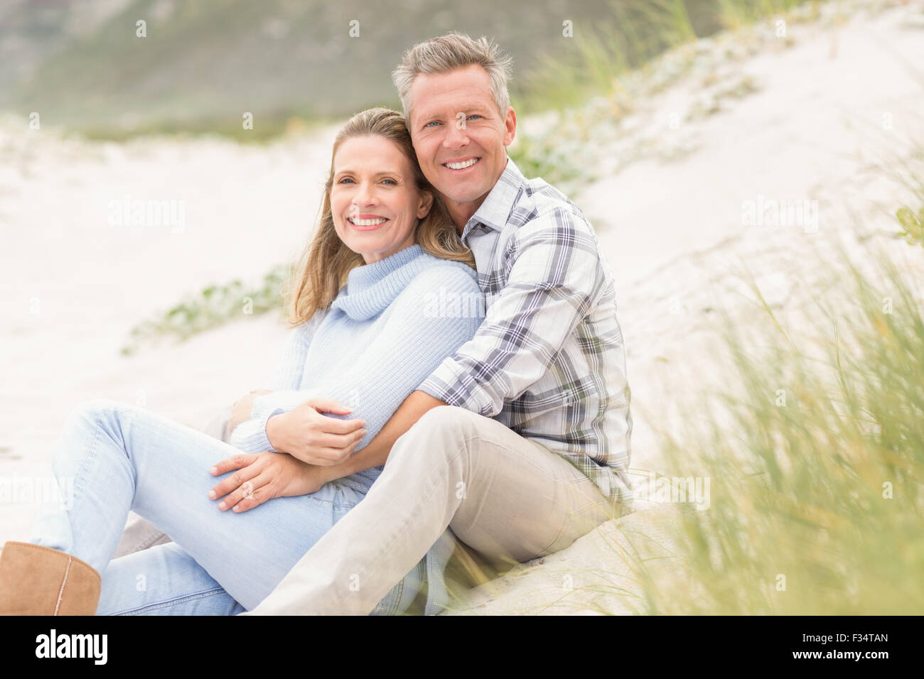 Smiling couple sitting together Stock Photo - Alamy