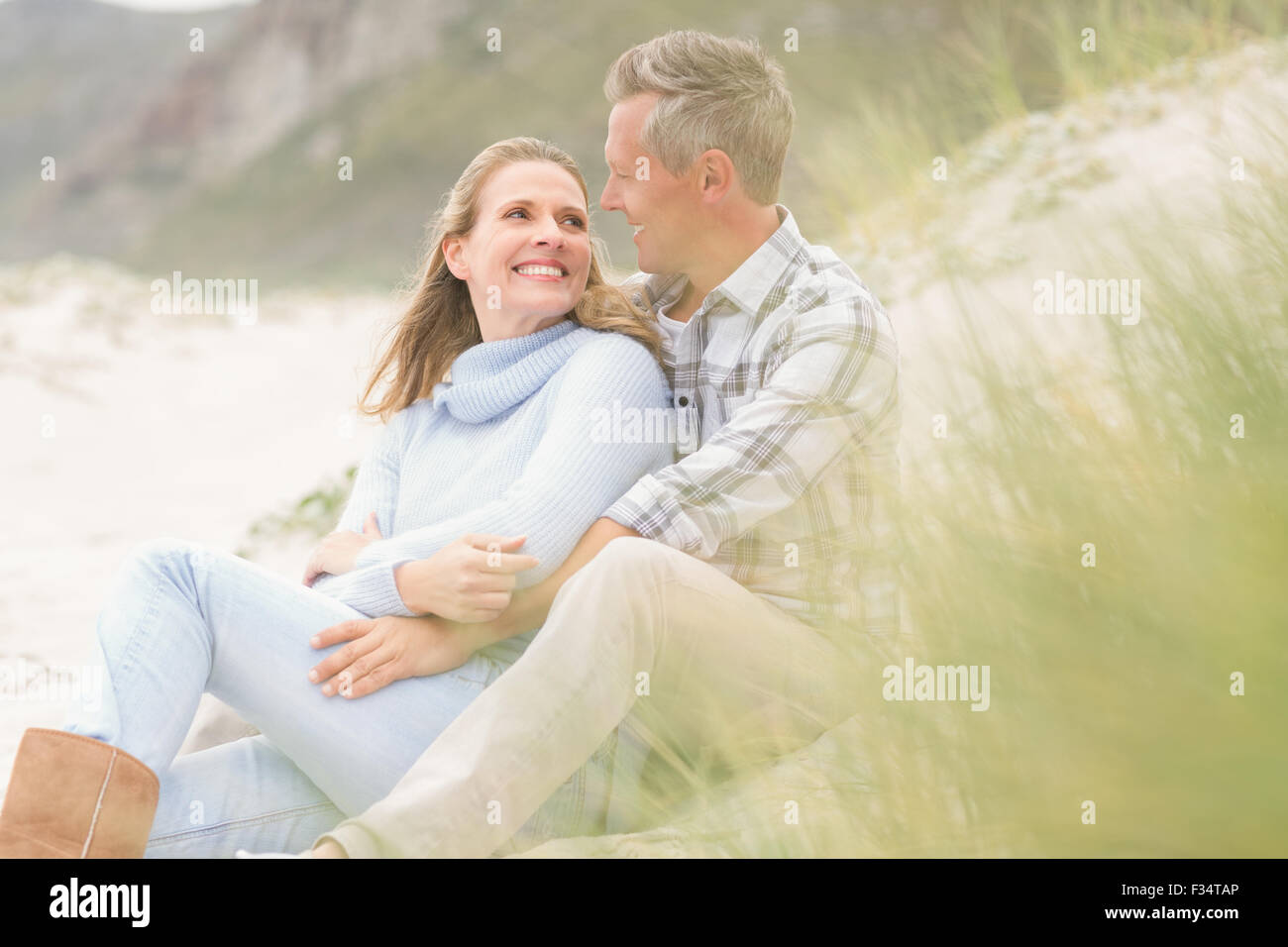 Smiling couple sitting together Stock Photo - Alamy