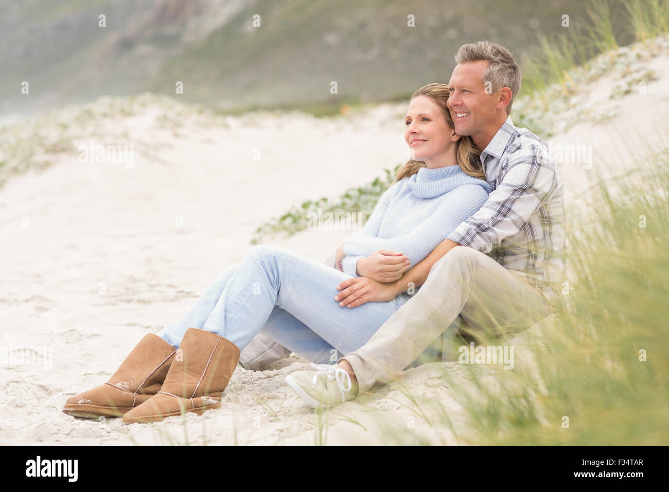 Smiling couple sitting together Stock Photo - Alamy