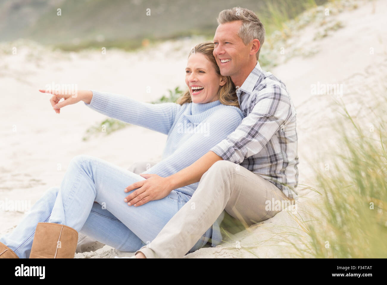 Smiling couple sitting together Stock Photo - Alamy