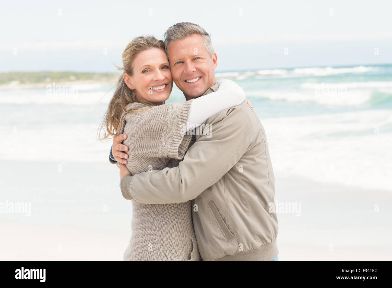 Happy couple holding each other Stock Photo - Alamy