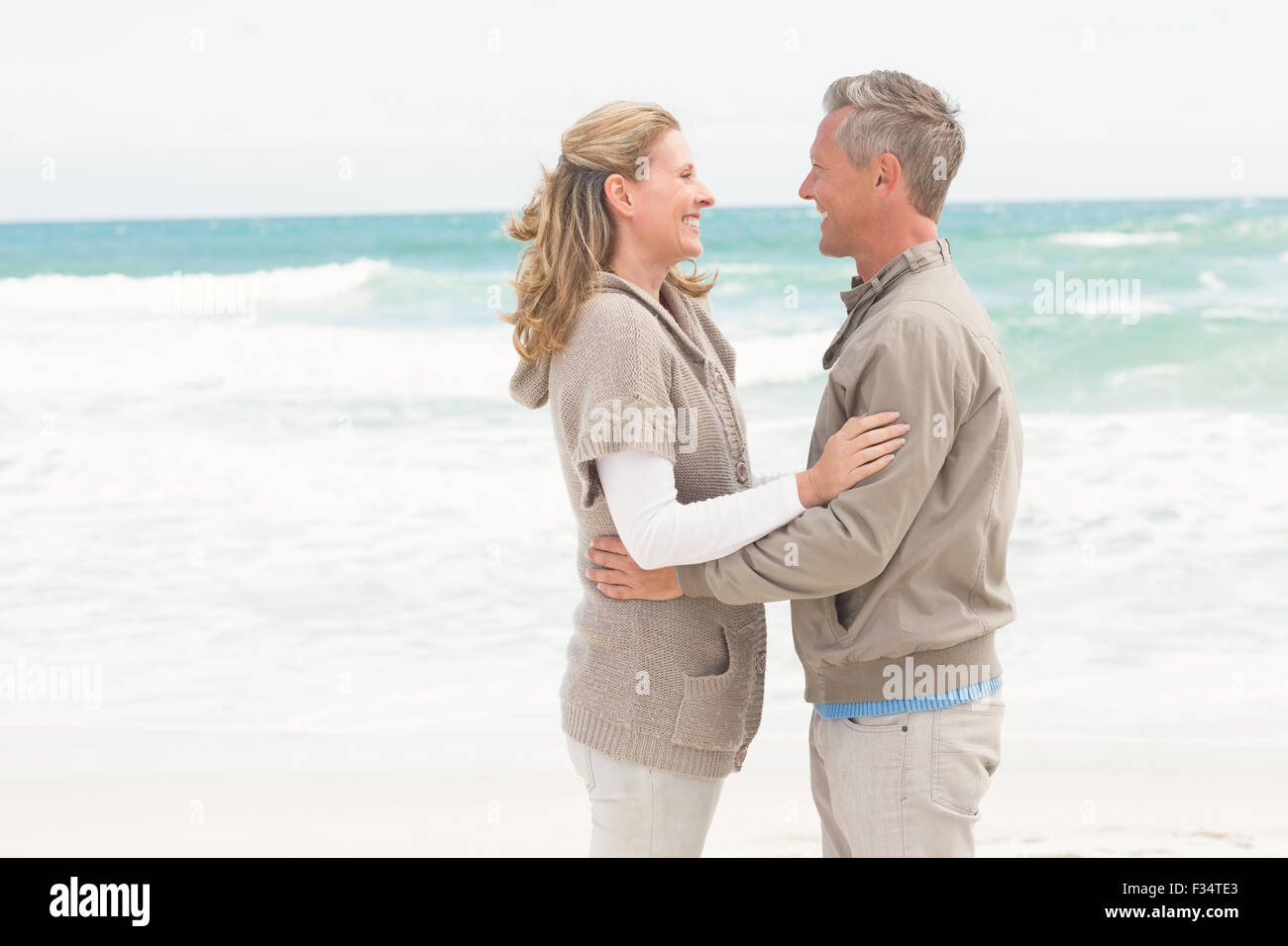 Happy couple holding each other Stock Photo - Alamy