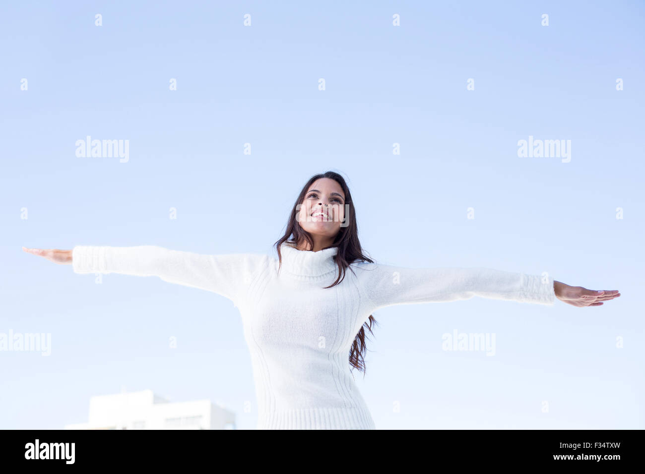 Pretty brunette feeling the air with arms raised up Stock Photo - Alamy