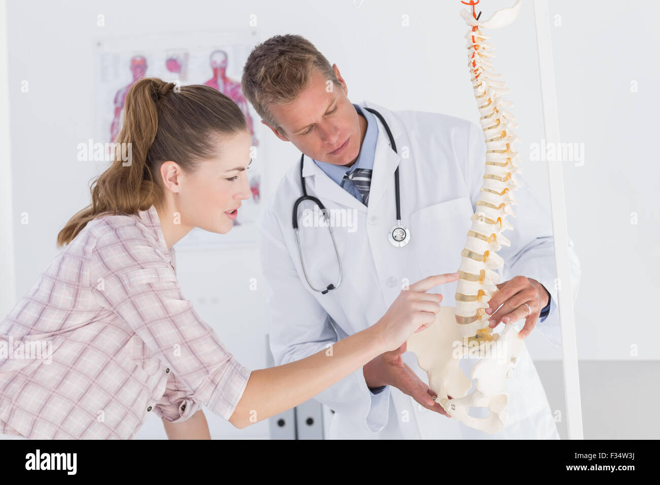 Doctor explaining anatomical spine to his patient Stock Photo - Alamy