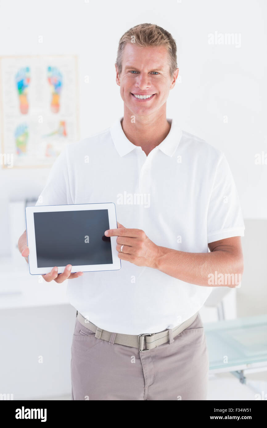Smiling doctor showing laptop pc Stock Photo - Alamy