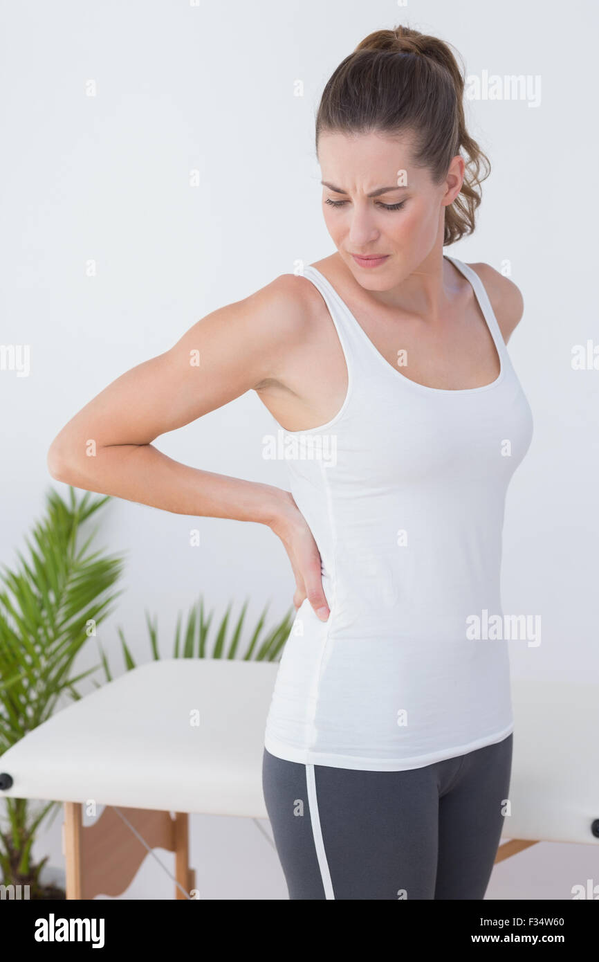 Suffering patient touching his back Stock Photo - Alamy