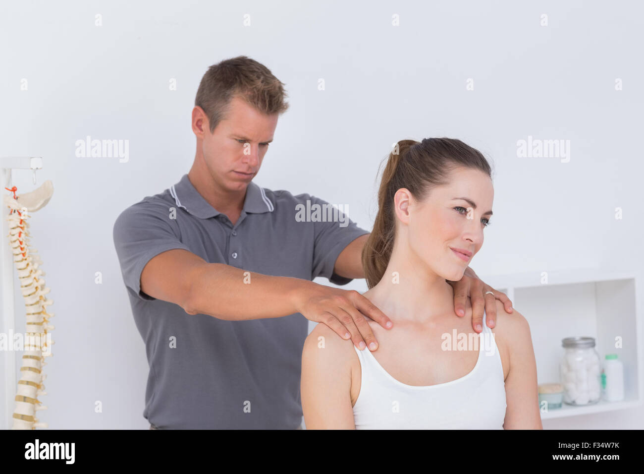 Doctor examining his patient neck Stock Photo - Alamy