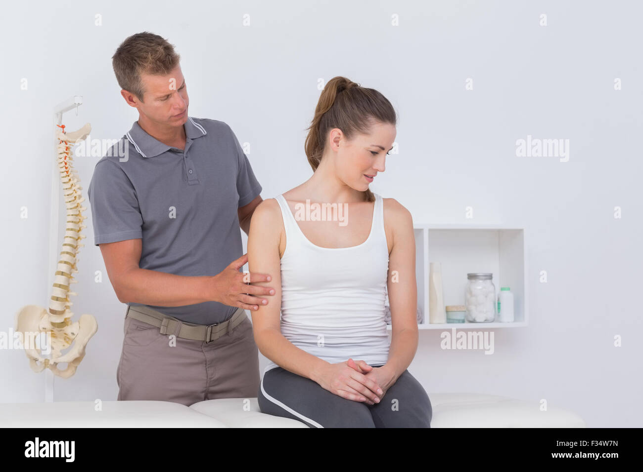 Doctor stretching woman arm Stock Photo - Alamy