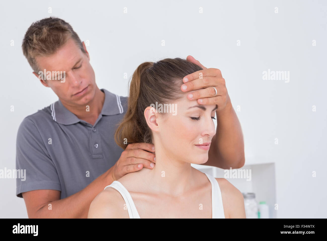 Doctor doing neck adjustment Stock Photo - Alamy
