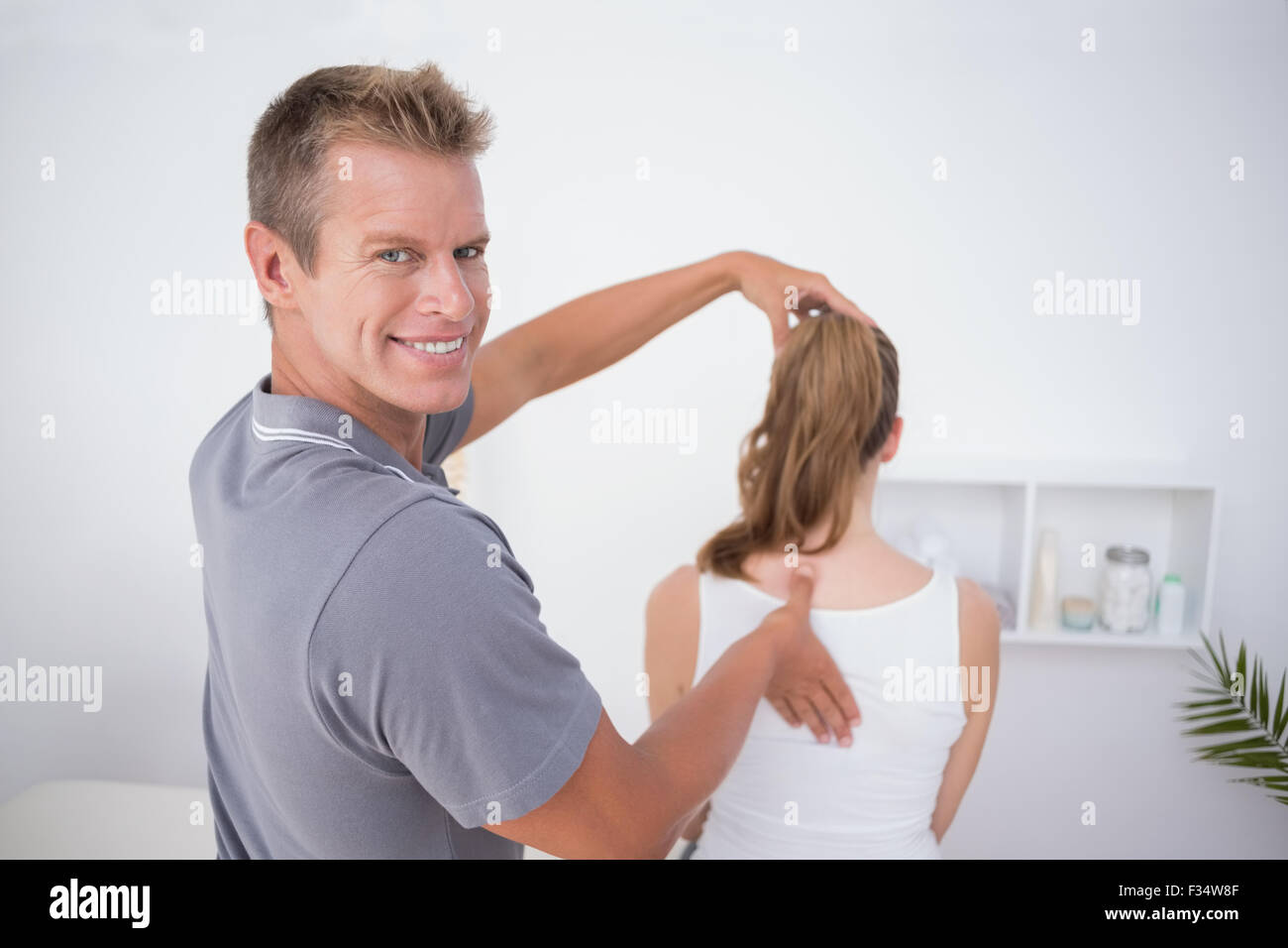 Doctor examining his patient back Stock Photo - Alamy