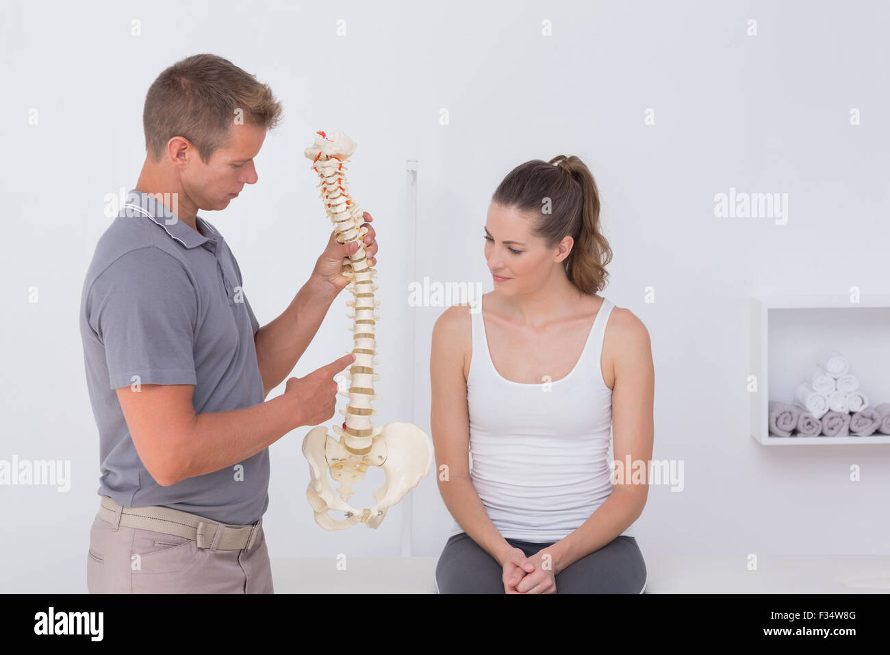 Doctor showing anatomical spine to his patient Stock Photo - Alamy
