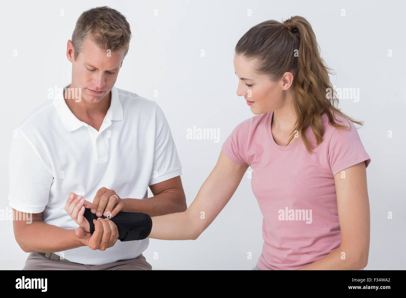 Doctor examining a man wrist Stock Photo - Alamy
