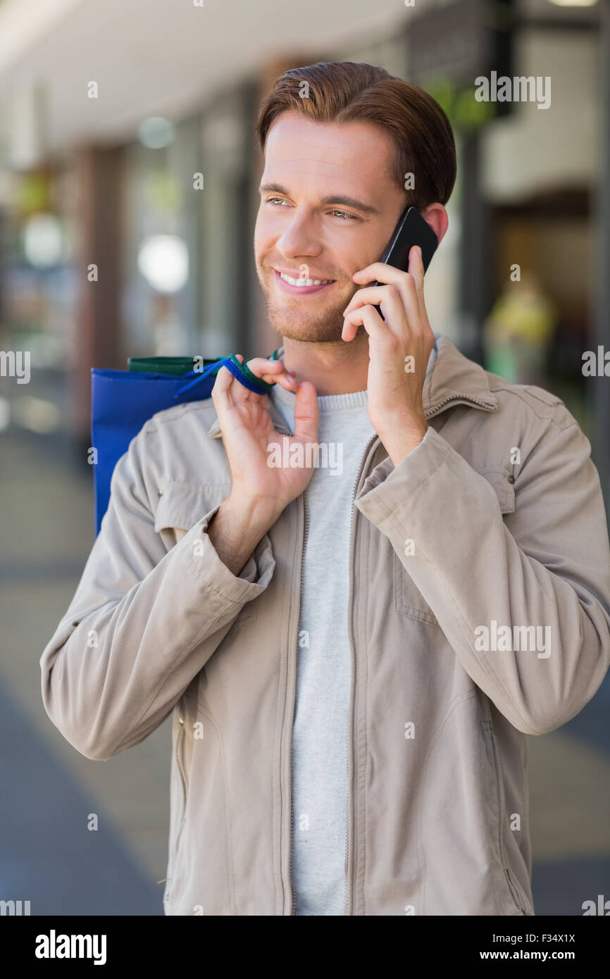 Portrait of a smiling man using his phone Stock Photo - Alamy