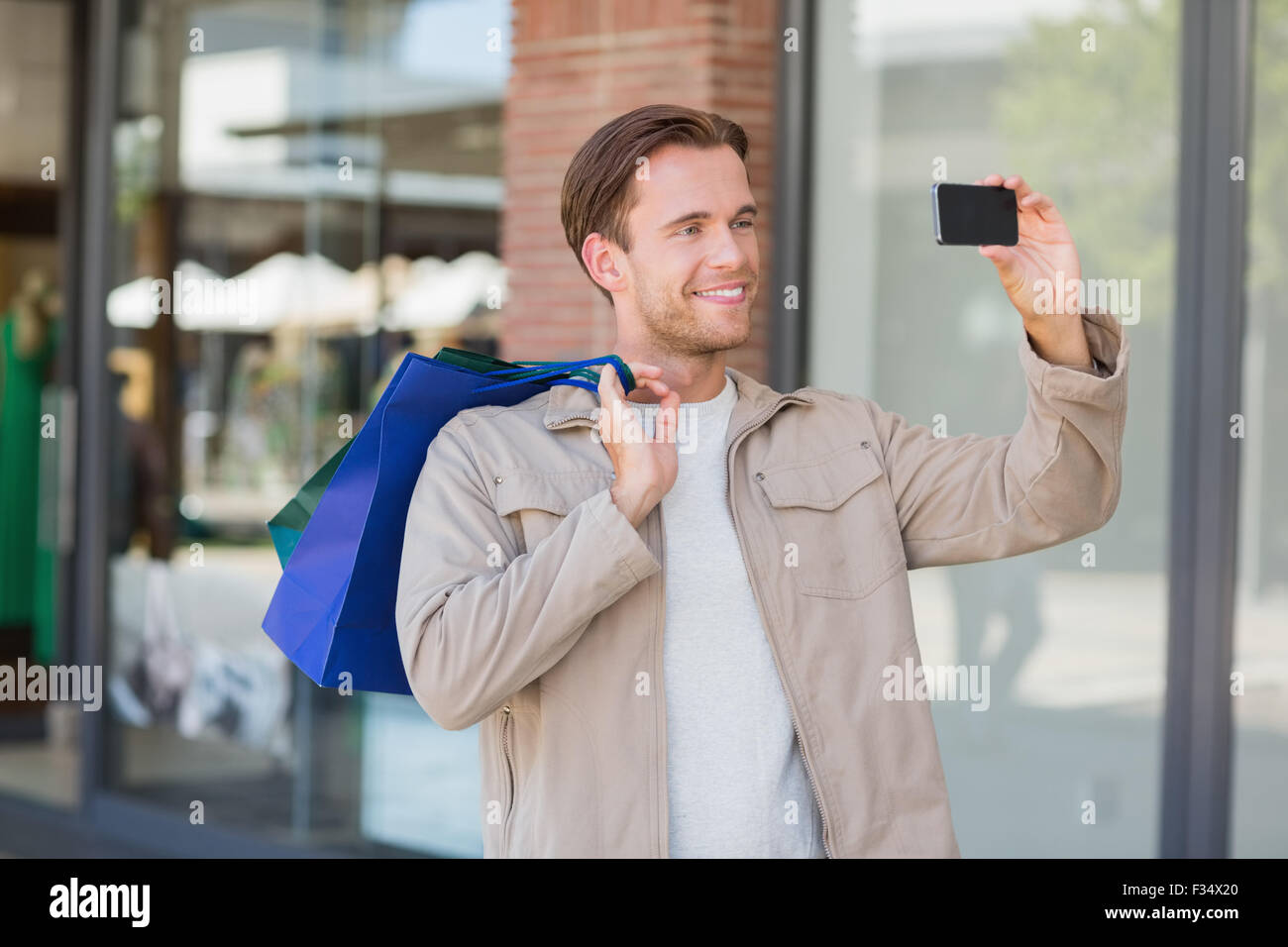 A smiling man taking a selfie Stock Photo - Alamy