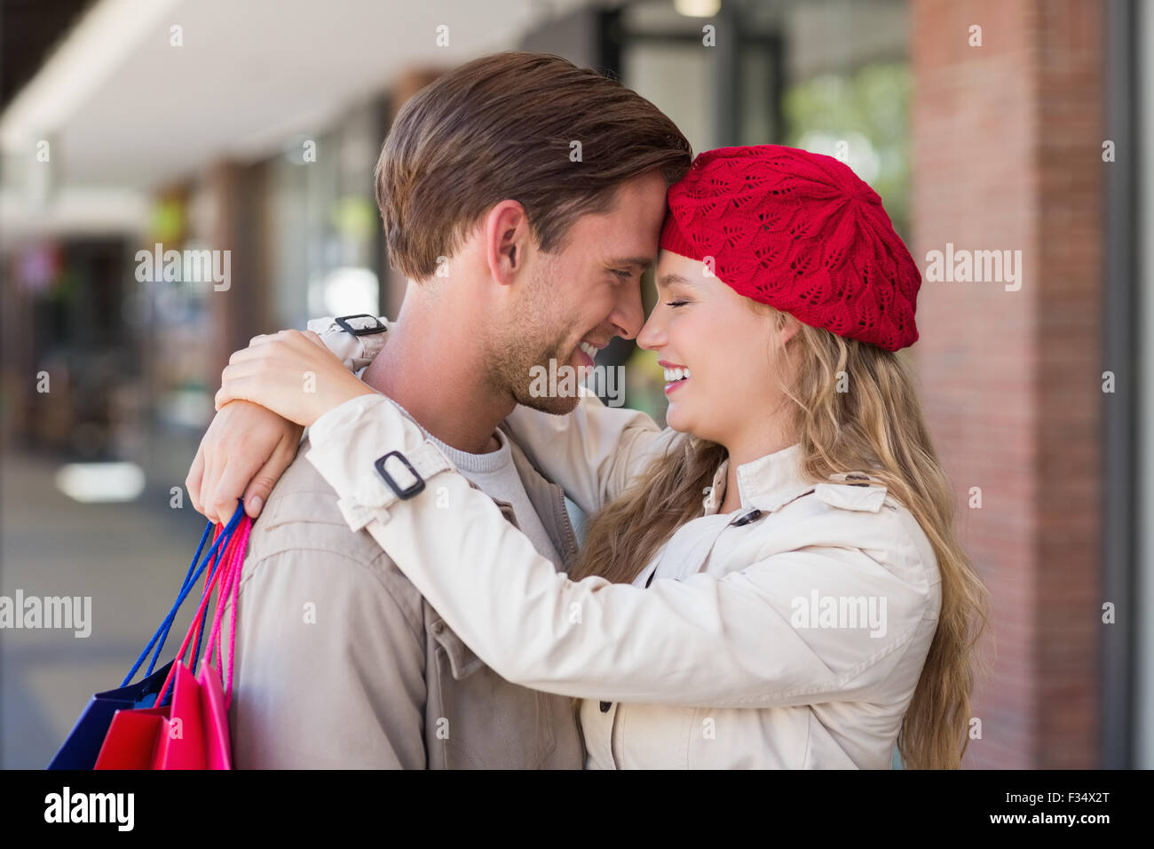 A smiling happy woman hugging her boyfriend Stock Photo - Alamy