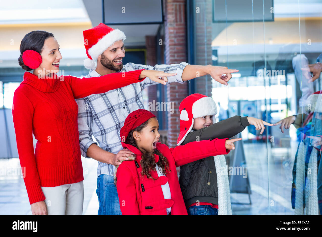 Happy family pointing at something Stock Photo - Alamy