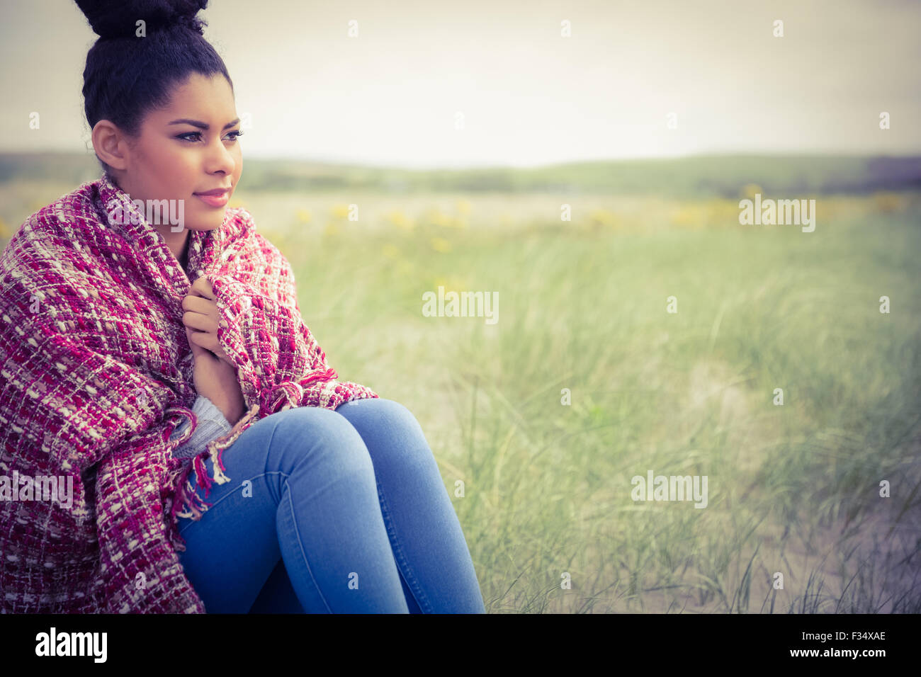 Beautiful woman wrapped up in warm clothing Stock Photo - Alamy