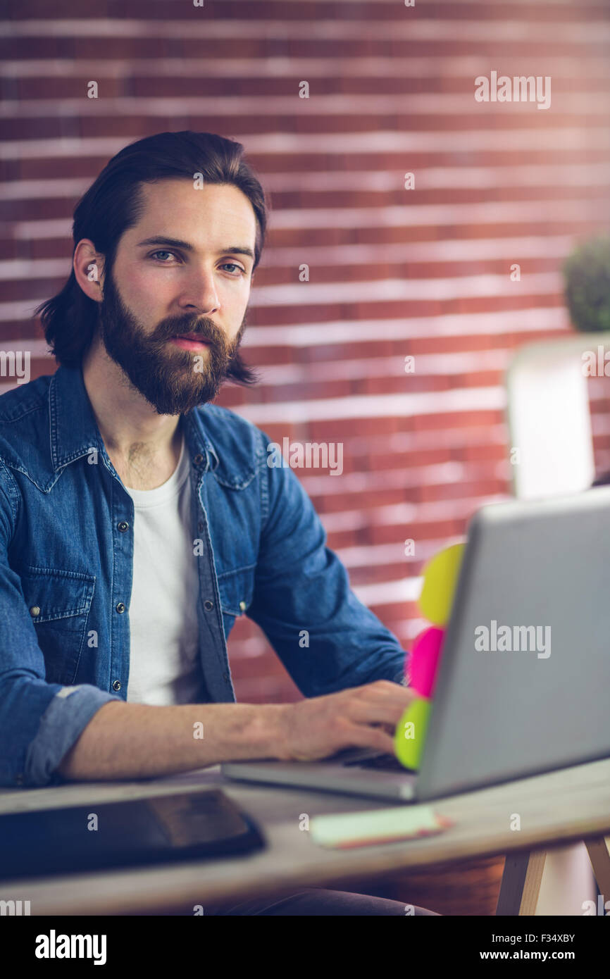 Portrait of smart businessman using laptop Stock Photo - Alamy