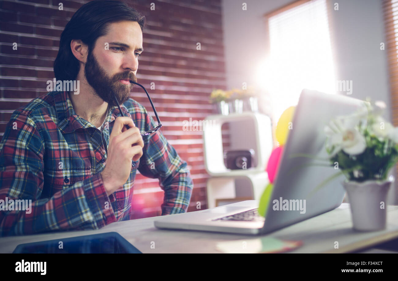 Thoughtful businessman using laptop Stock Photo - Alamy