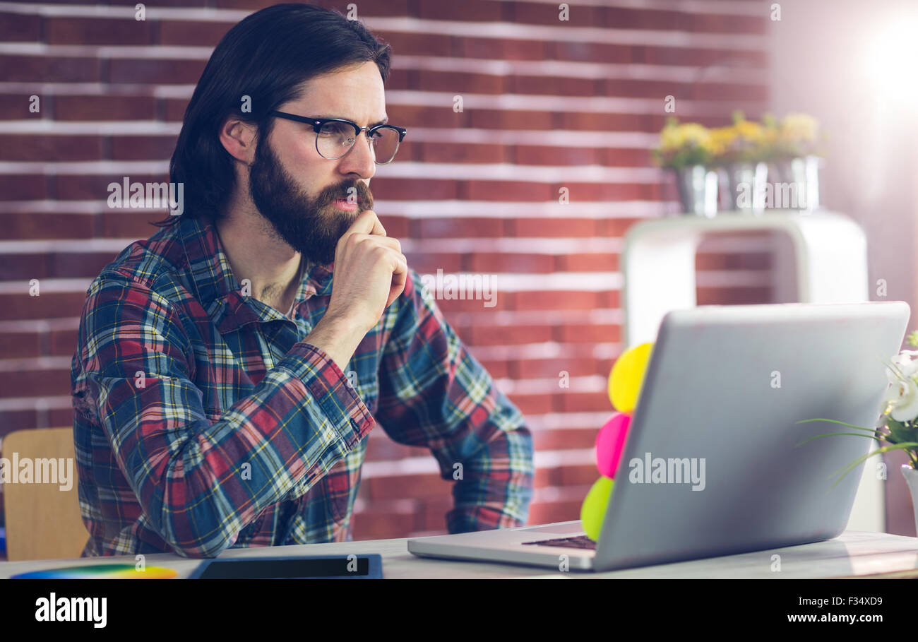 Confident businessman using laptop on desk Stock Photo - Alamy