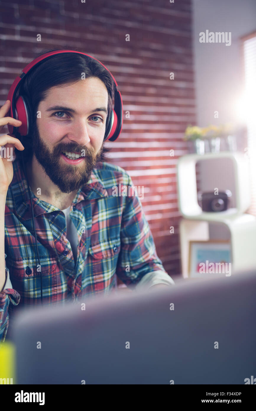 Portrait of businessman wearing headphones at office Stock Photo - Alamy