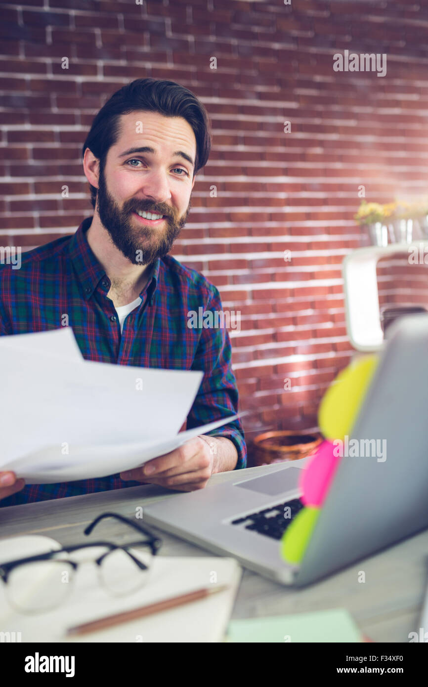Portrait of smiling creative businessman with documents Stock Photo - Alamy