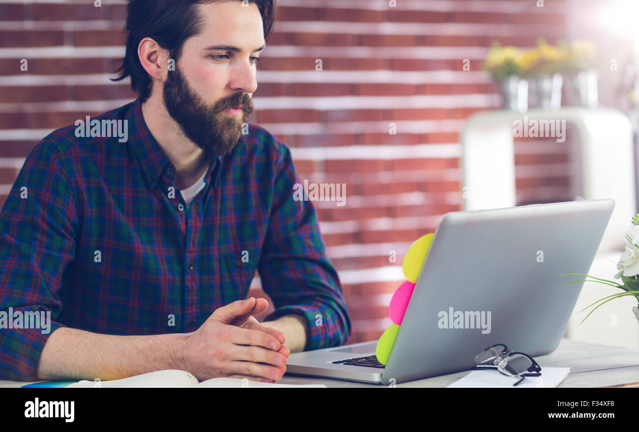 Serious creative editor working on laptop Stock Photo - Alamy