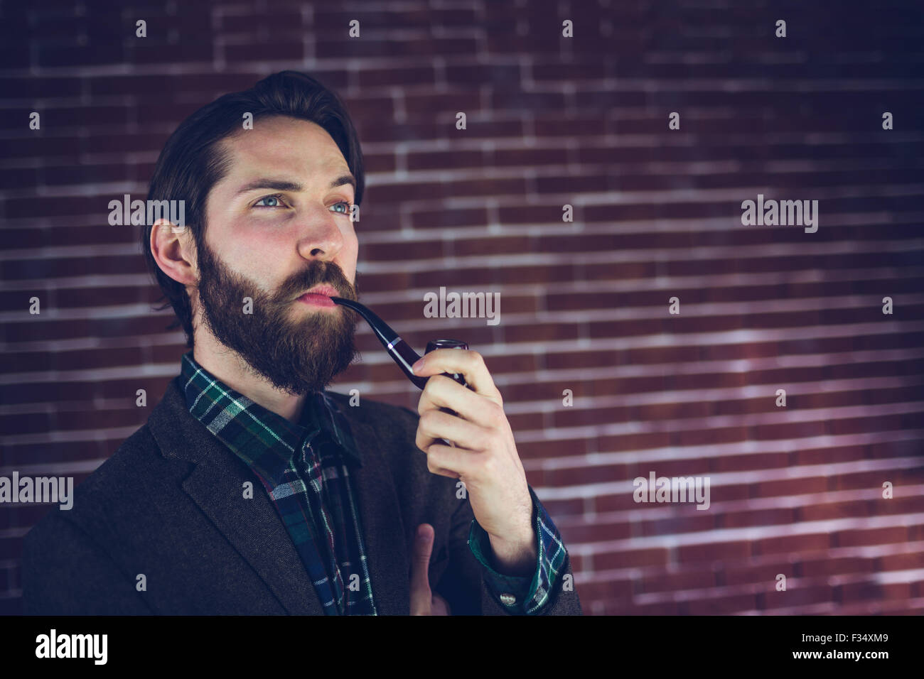 Handsome man smoking pipe Stock Photo - Alamy