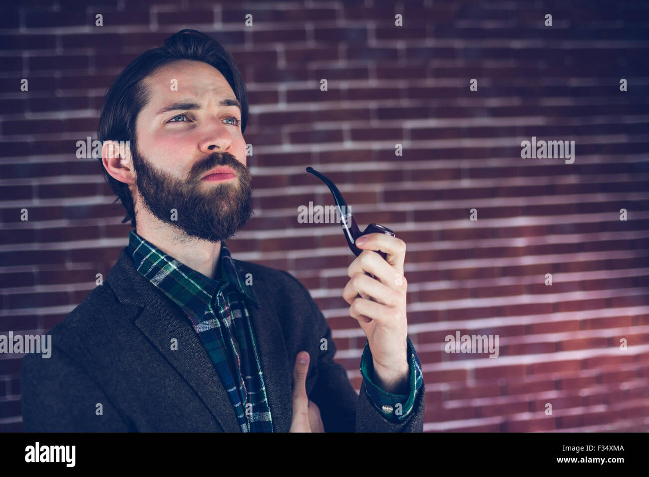 Thoughtful man smoking pipe Stock Photo - Alamy