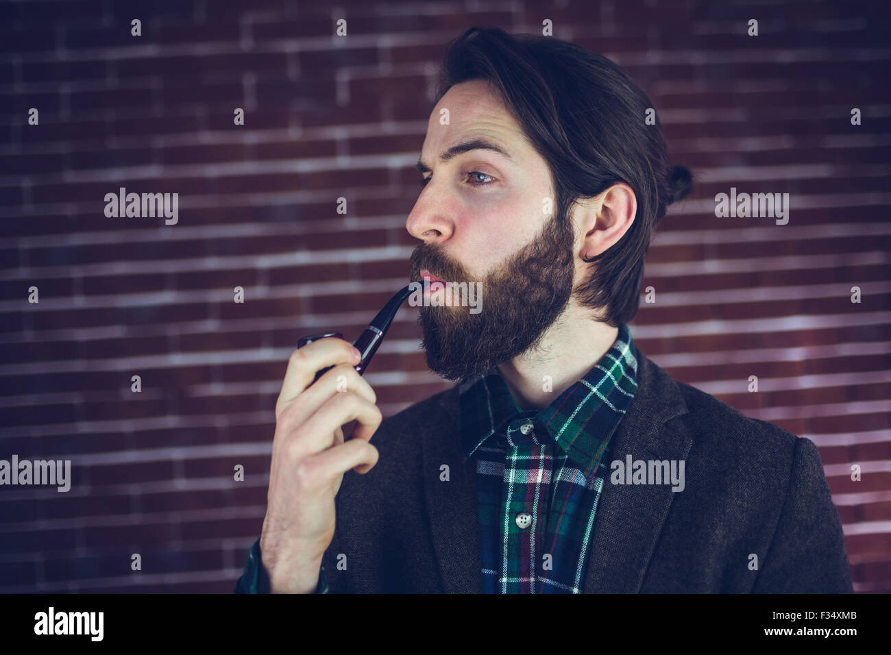 Fashionable man smoking pipe Stock Photo - Alamy