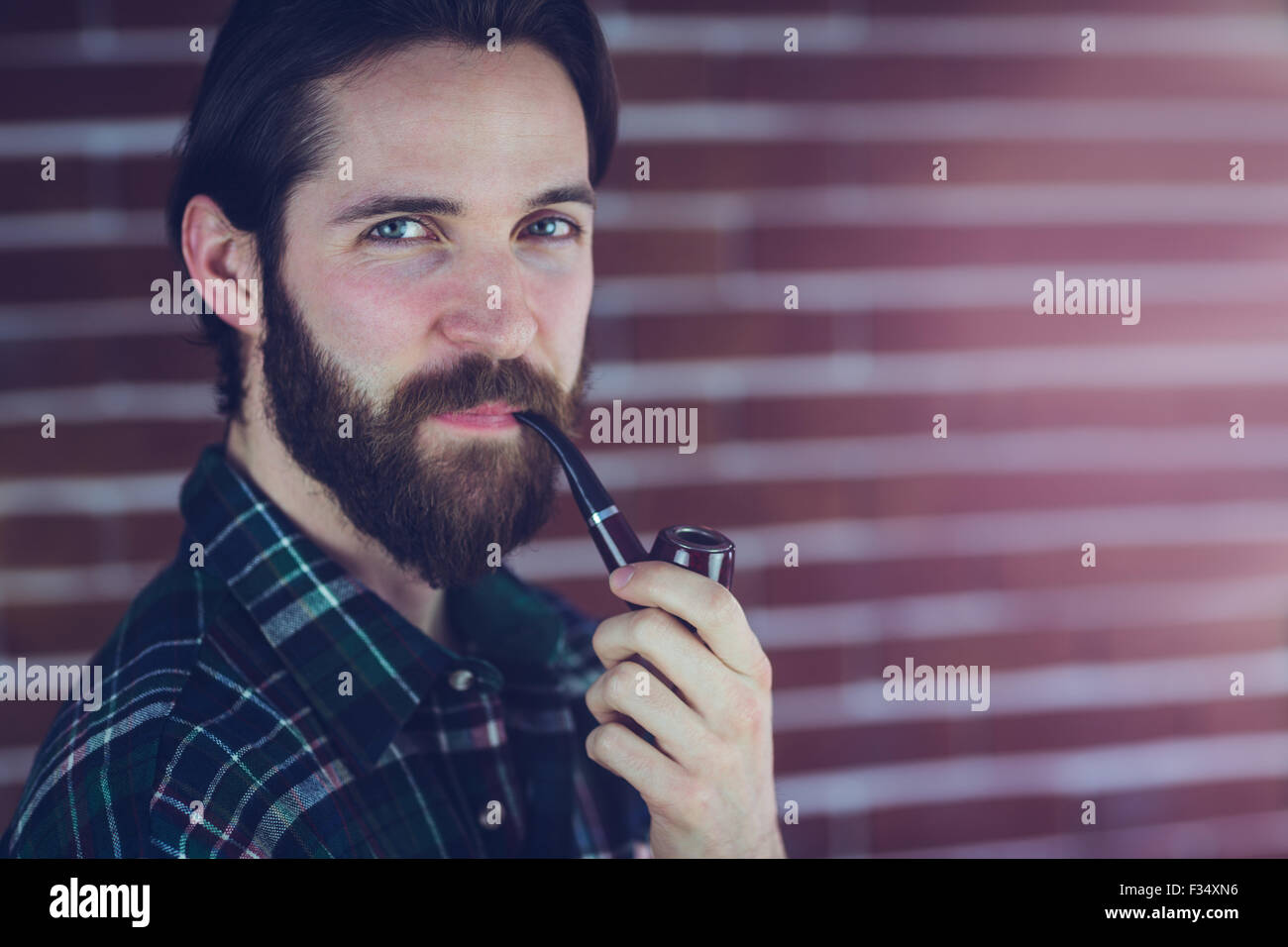 Portrait of smiling man with smoking pipe Stock Photo - Alamy