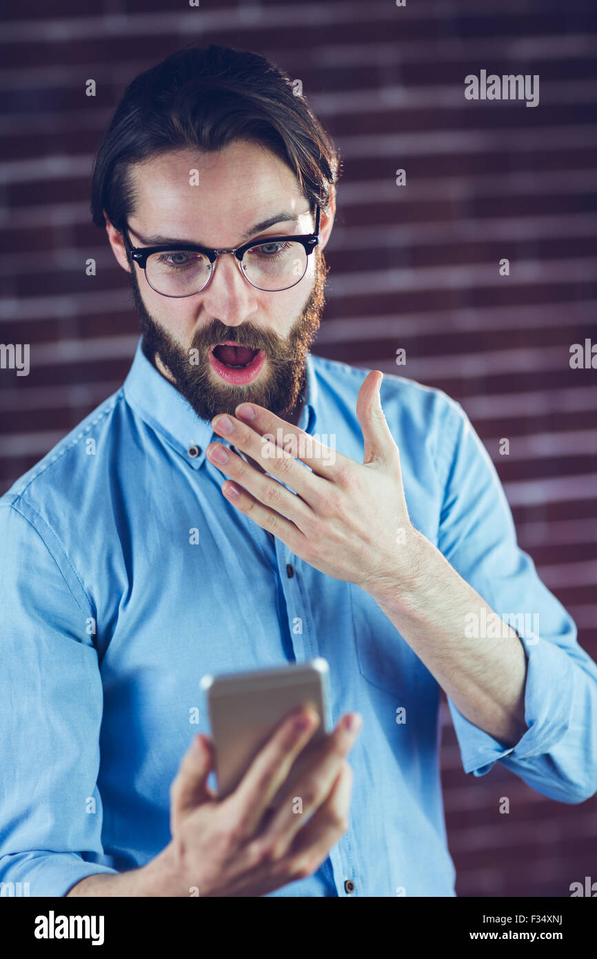 Shocked man using smartphone Stock Photo - Alamy