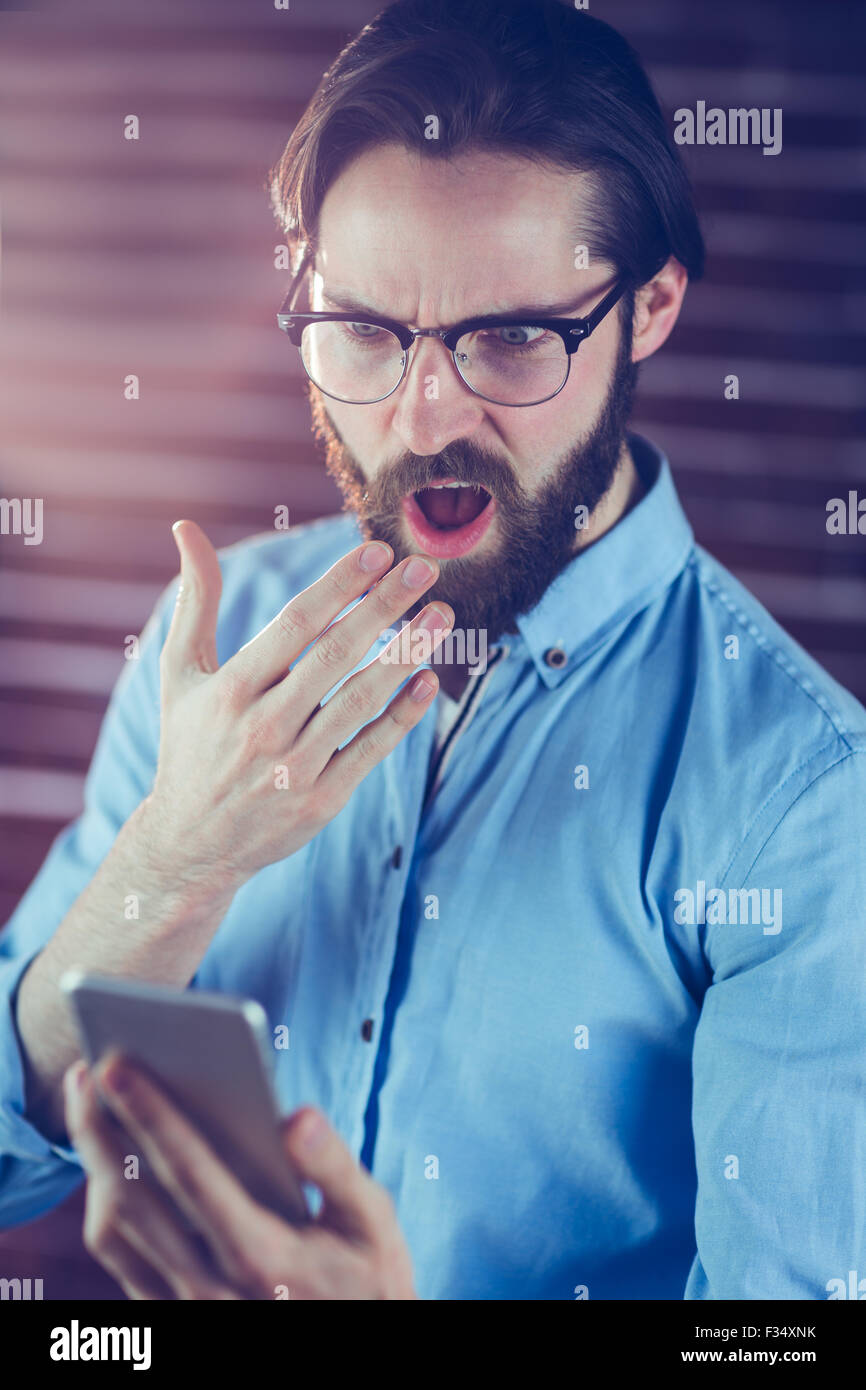 Shocked man looking at smartphone Stock Photo - Alamy