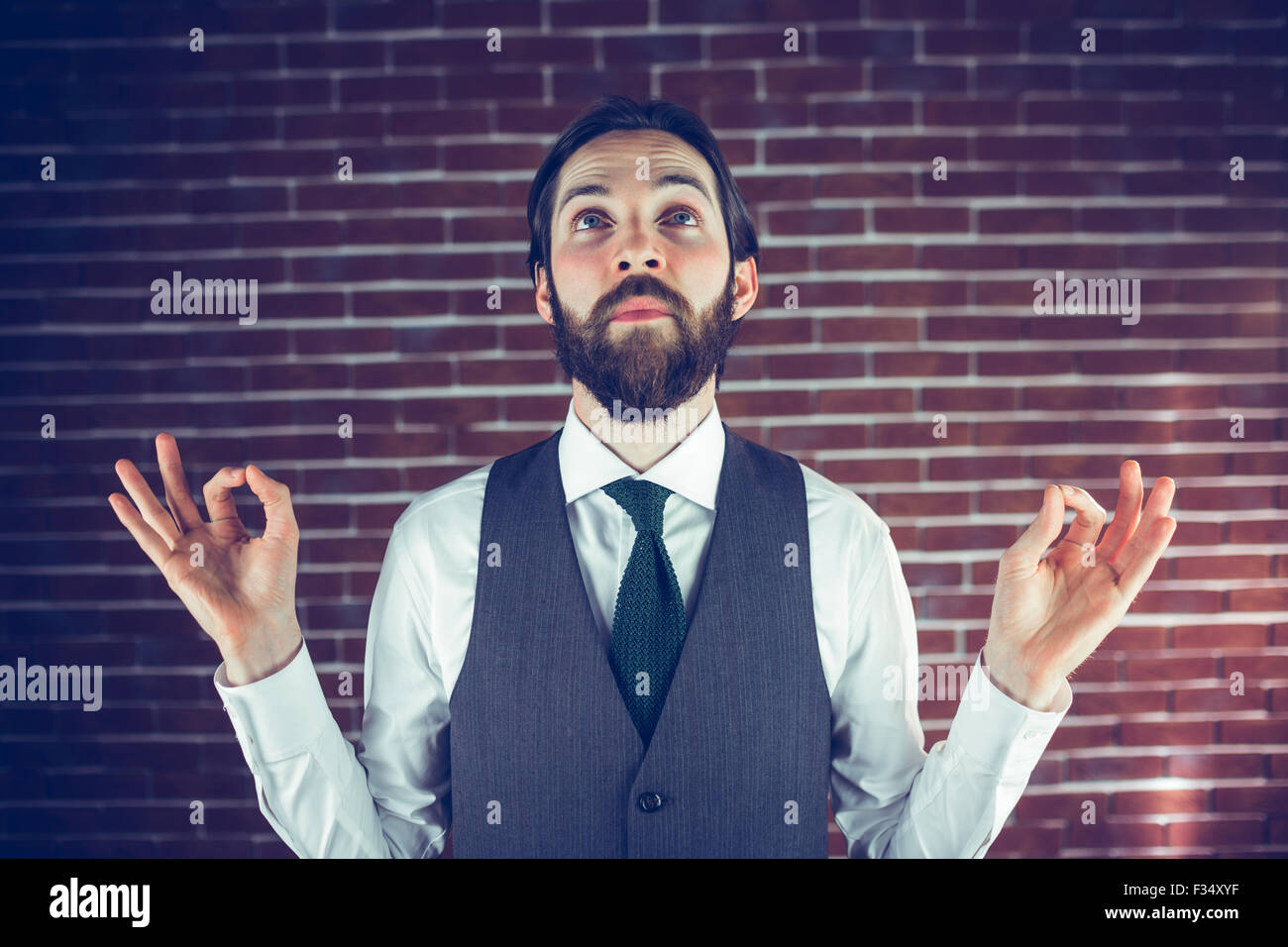 Serious man looking up while gesturing Stock Photo - Alamy