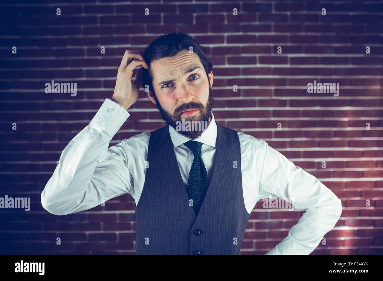 Portrait of man scratching head Stock Photo - Alamy