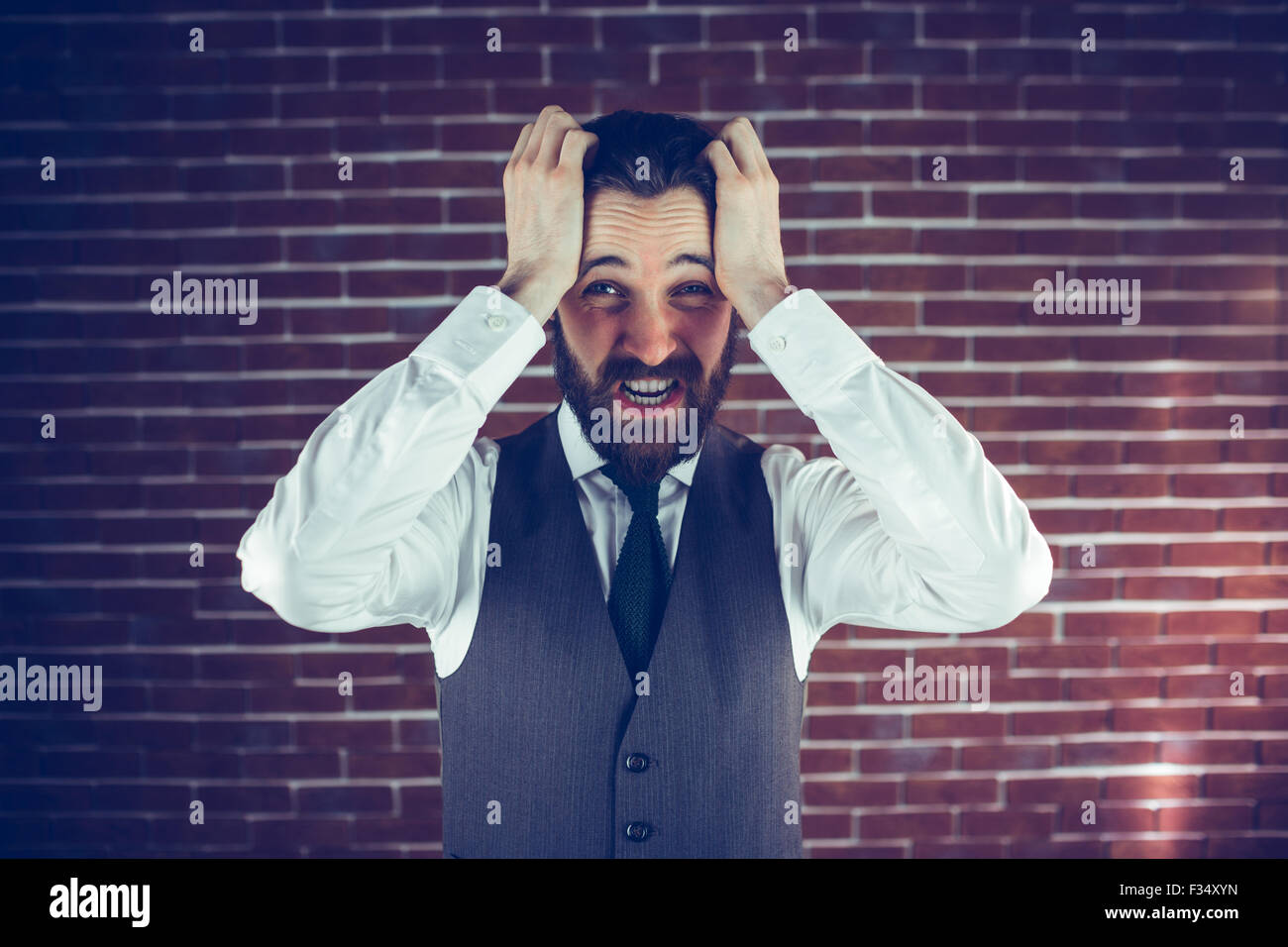 Portrait angry man with head in hands Stock Photo - Alamy