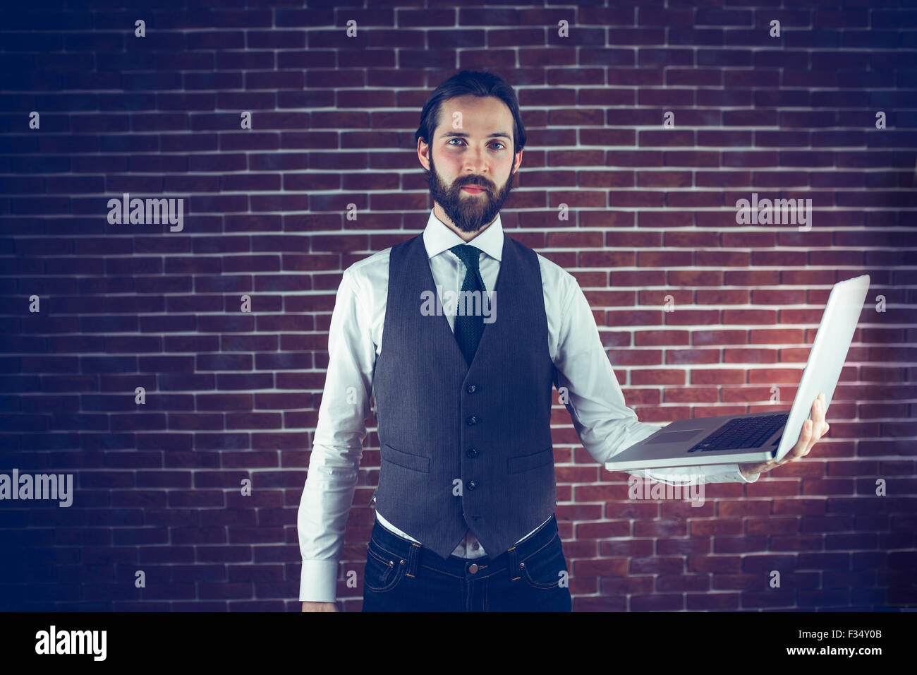 Portrait of smart man holding laptop Stock Photo - Alamy