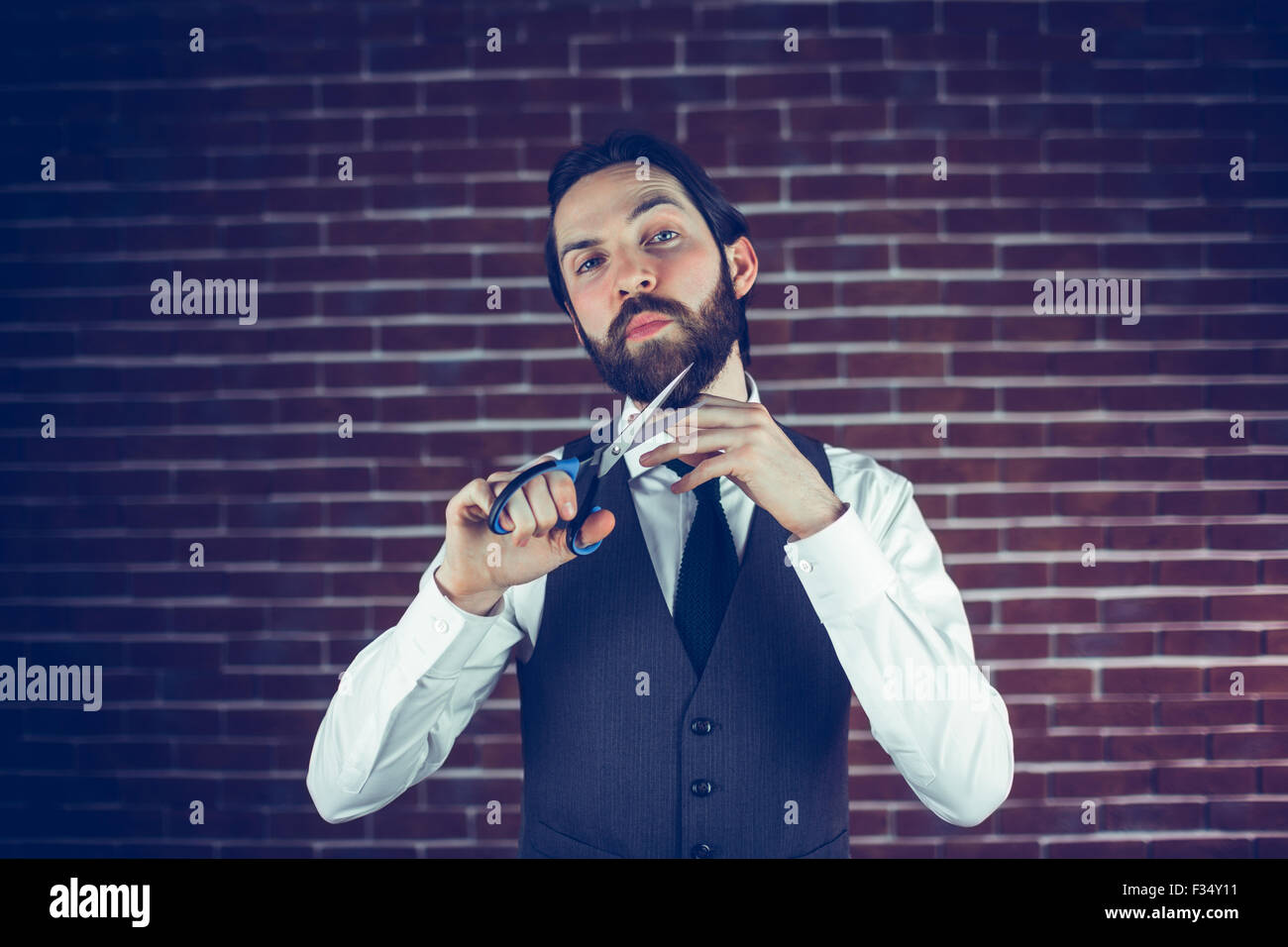 Portrait of man holding scissors Stock Photo - Alamy