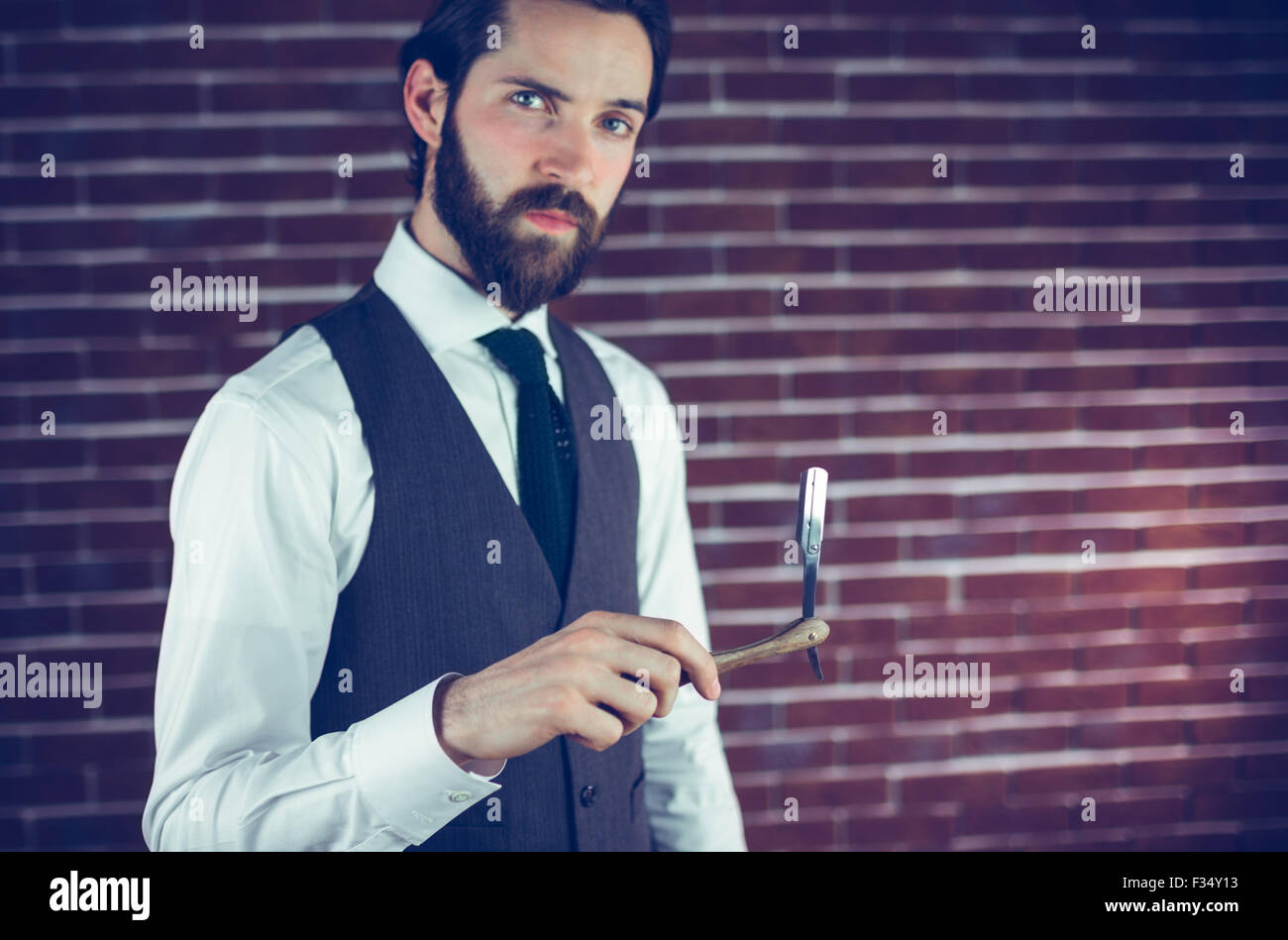 Portrait of serious man holding razor Stock Photo - Alamy