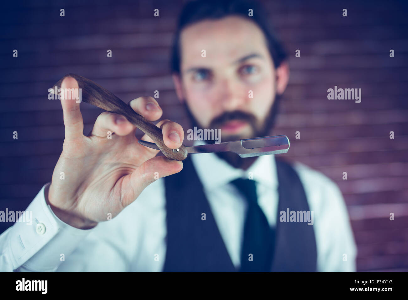 Portrait of smart hipster holding razor Stock Photo - Alamy